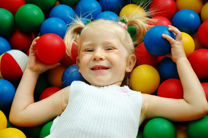 Girl Child Having Fun Playing in Colored Balls Stock Image - Image of ...