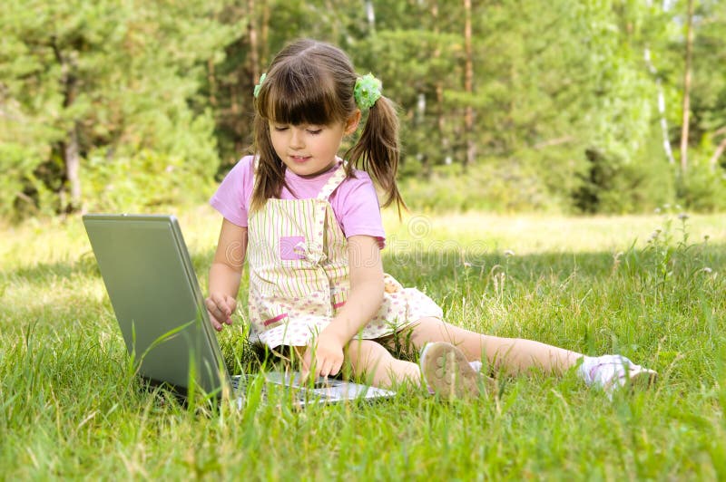 Little girl with computer stock photo. Image of mood - 10388928