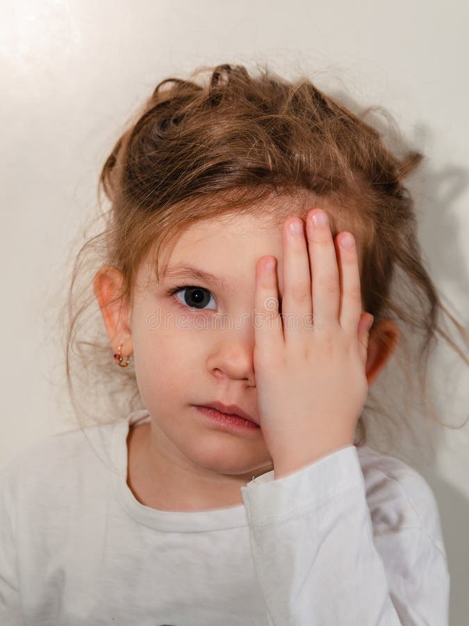 Little Girl Covers One Eye with Her Hand, Vision Test. Stock Image ...