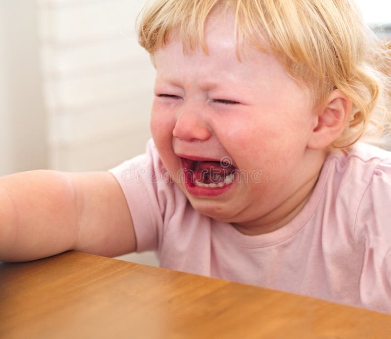 Little girl crying stock image. Image of table, people - 55959377