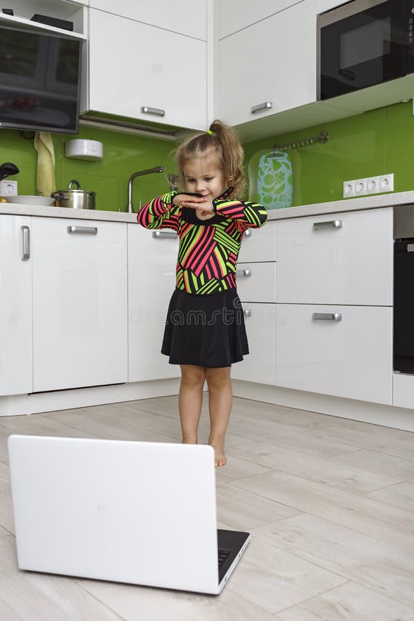 Little Girl Dancing in Front of a Laptop at Home Stock Photo - Image of ...