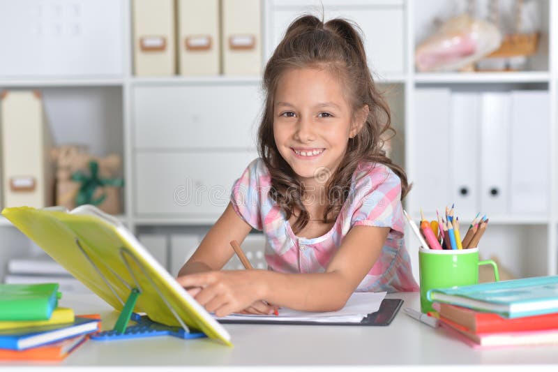 Little Girl Does Her Homework at the Table at Home Stock Image - Image ...