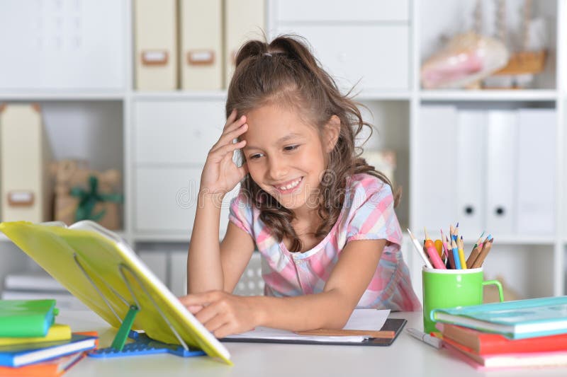 Little Girl Does Her Homework at the Table at Home Stock Image - Image ...