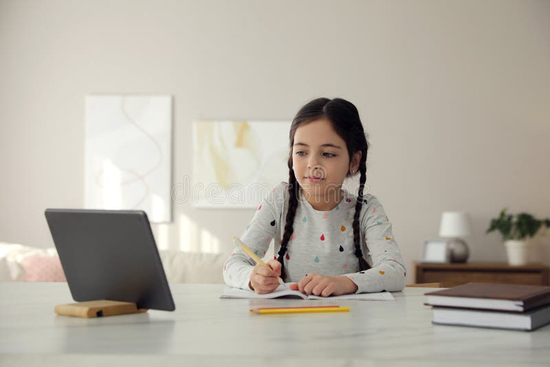 Little Girl Doing Homework with Tablet at Home Stock Image - Image of ...