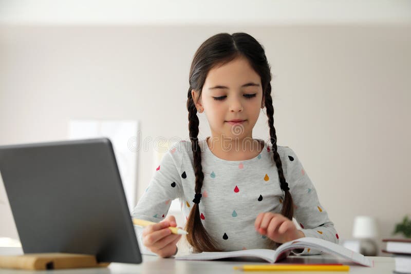 Little Girl Doing Homework with Modern Tablet at Home Stock Photo ...