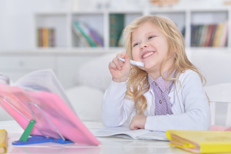 Little girl doing homework stock image. Image of creativity - 87778329
