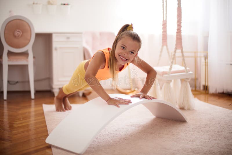 Little Girl Doing Push-ups in the Bedroom. Stock Photo - Image of happy ...