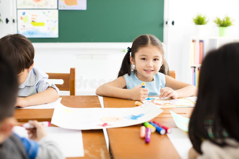 Little Girl Drawing in the Classroom Stock Image - Image of artist ...