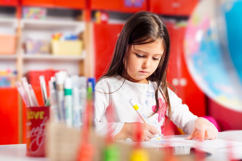 Little Girl Drawing on Her Book and Having Fun at Play Table Stock ...