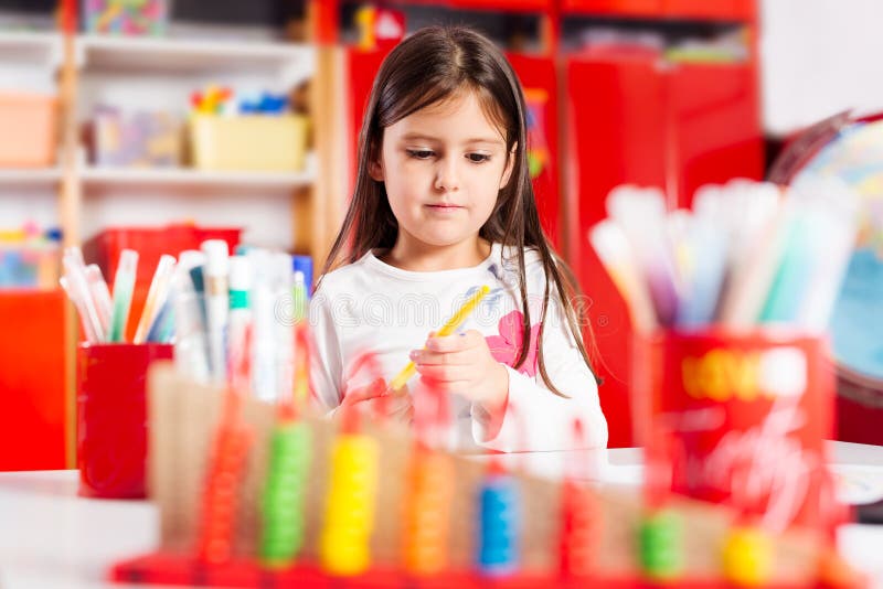 Little Girl Drawing on Her Book and Having Fun at Play Table Stock ...