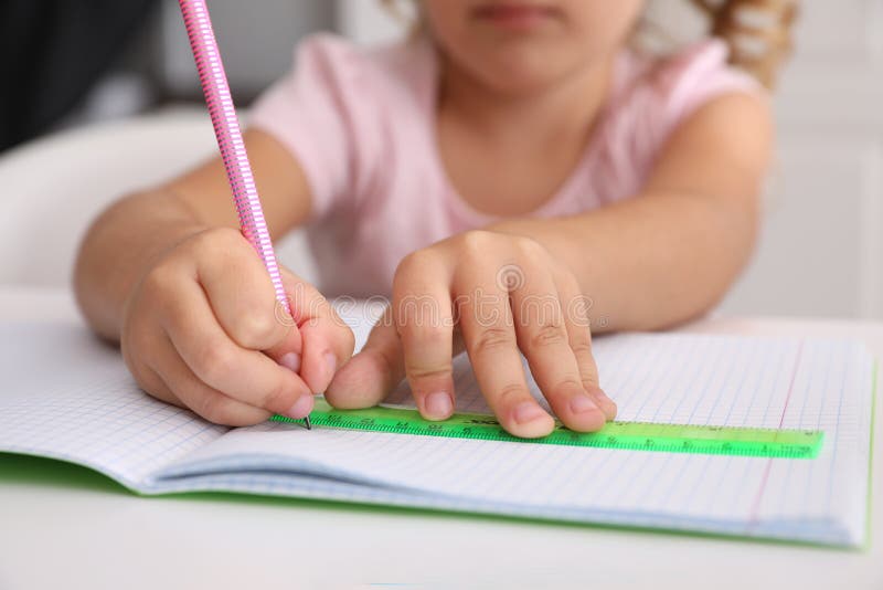 Little Girl Drawing with Ruler and Pencil at Table, Closeup. Doing ...