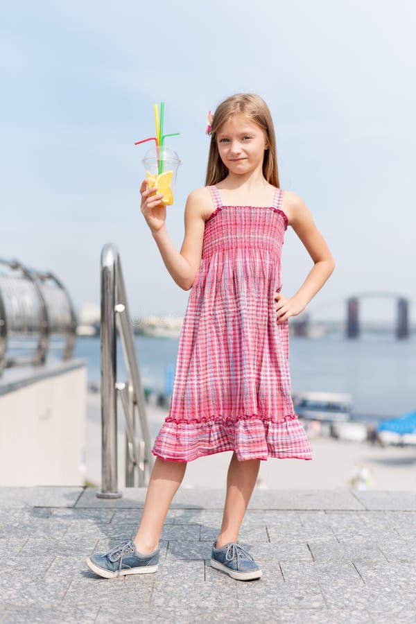 Little Girl Drinking Fruit Cocktail Outdoors in the Summer Day. Stock ...