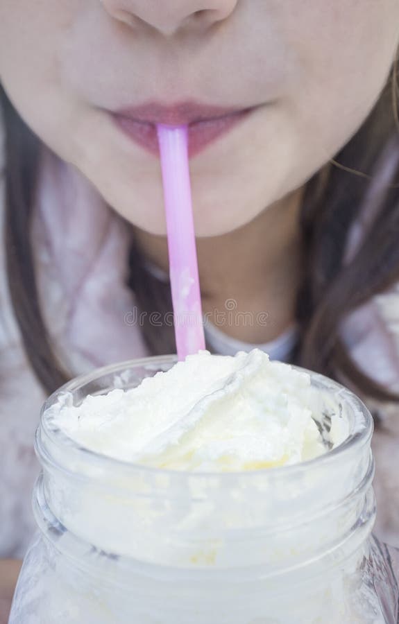 Little Girl Drinking Milkshake through a Pink Straw Stock Image - Image ...