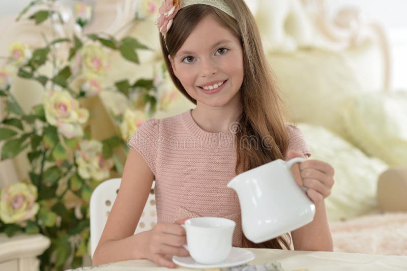 Little girl drinking tea stock photo. Image of cheerful - 75792982
