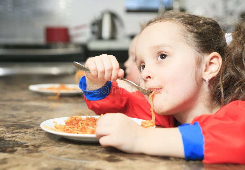 Little Girl Eat Pasta in the Kitchen Table Stock Image - Image of ...