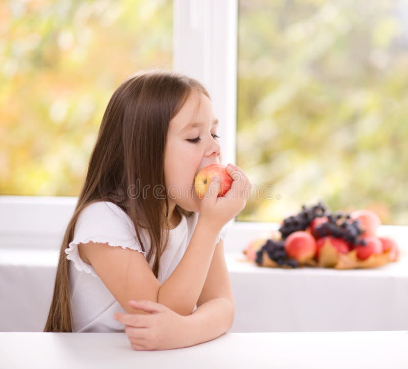 Child eating an apple stock image. Image of dietary, supplement - 18543177