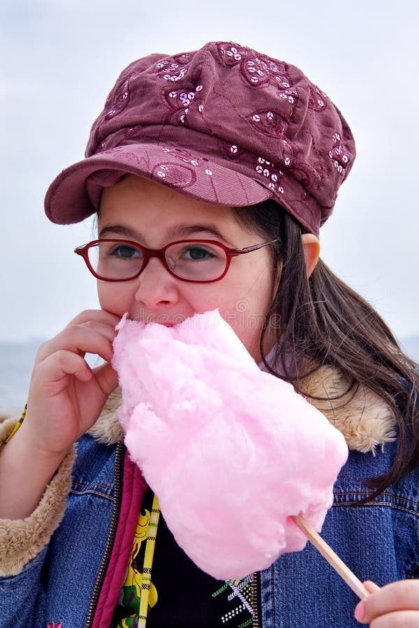 Little girl eating candy stock photo. Image of girl, funny - 9149338