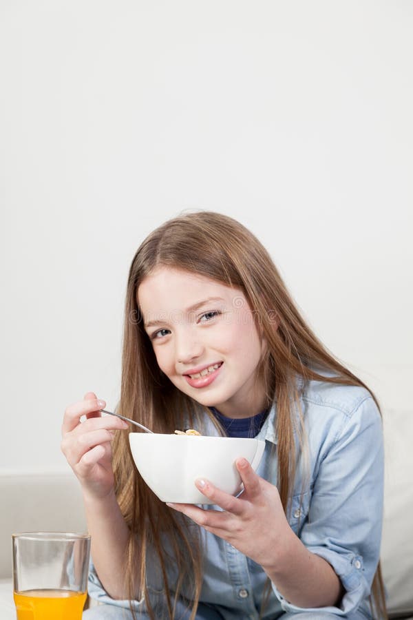 Little Girl Eating Cereal in the Breakfast Stock Photo - Image of girl ...