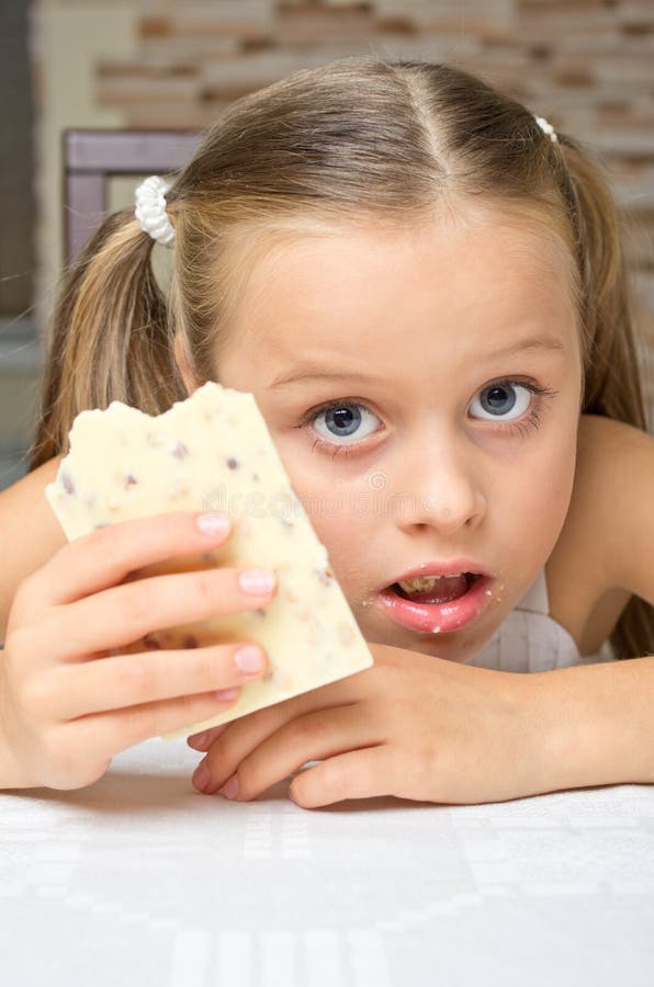 Little Girl Eating an Chocolate Stock Photo - Image of blond, female ...
