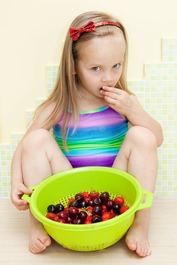 Little girl eating fruit stock photo. Image of portrait - 20223388