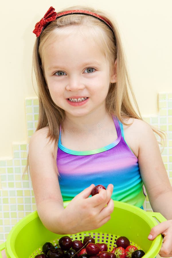 Little girl eating fruit stock photo. Image of beauty - 20223180