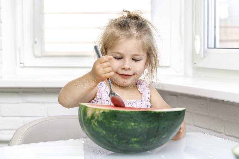 Little Girl Eating Half a Watermelon with a Spoon Stock Photo - Image ...