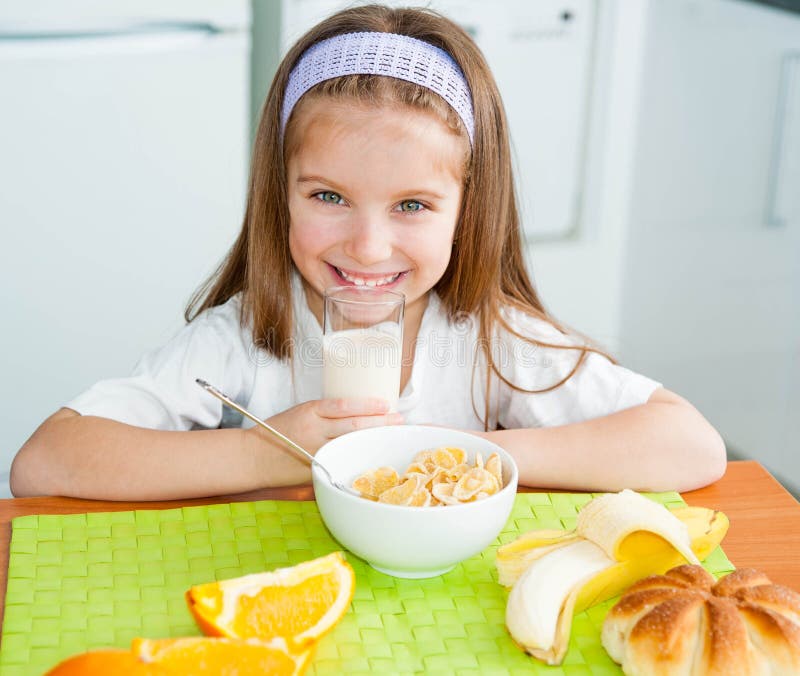 Little Girl Eating Her Breakfast Stock Photo - Image of flakes ...