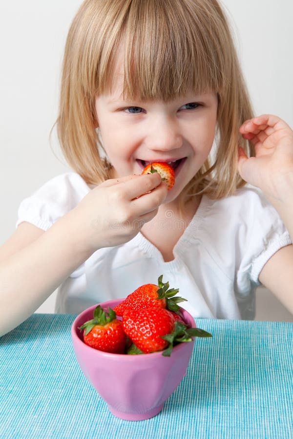 LIttle Girl Eating Strawberries Stock Photo - Image of vivid, food ...