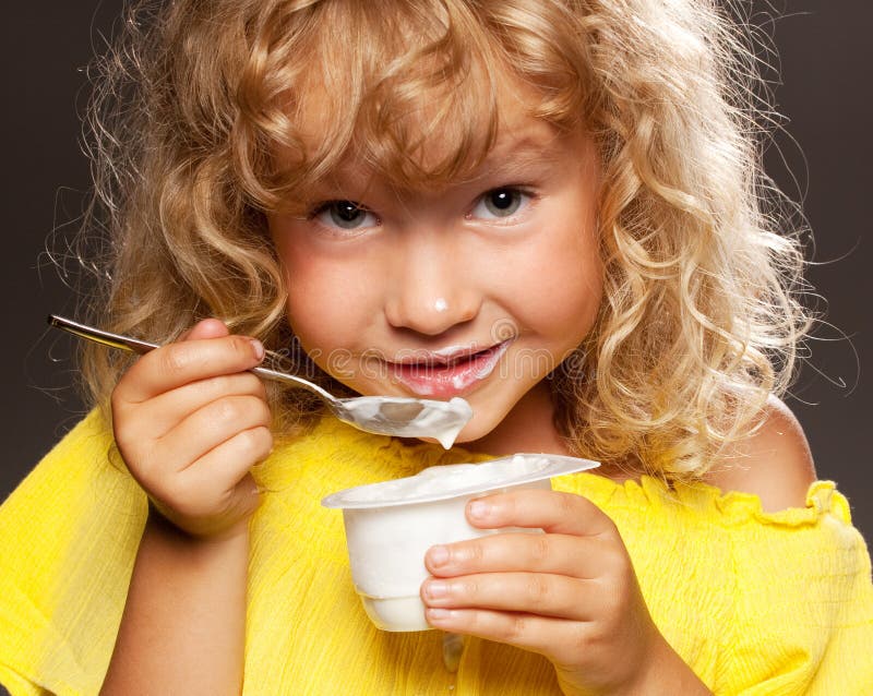 Little girl eating yogurt stock image. Image of breakfast - 21110585