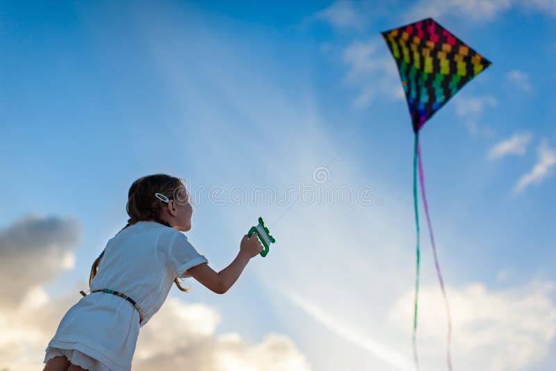 Little girl flying a kite stock photo. Image of adorable - 45524920