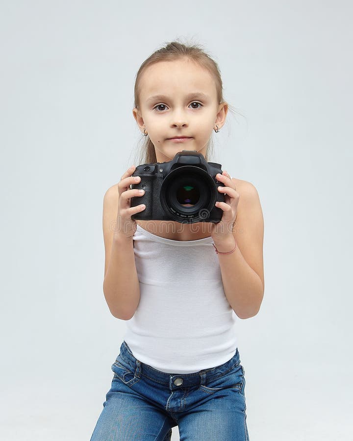 Little Girl with Glasses, Lying in the Studio with a Camera Stock Image ...