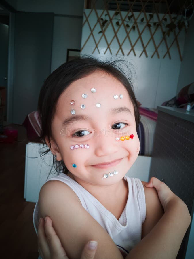 Little Girl with Glitter Stickers on Her Face Stock Photo - Image of ...
