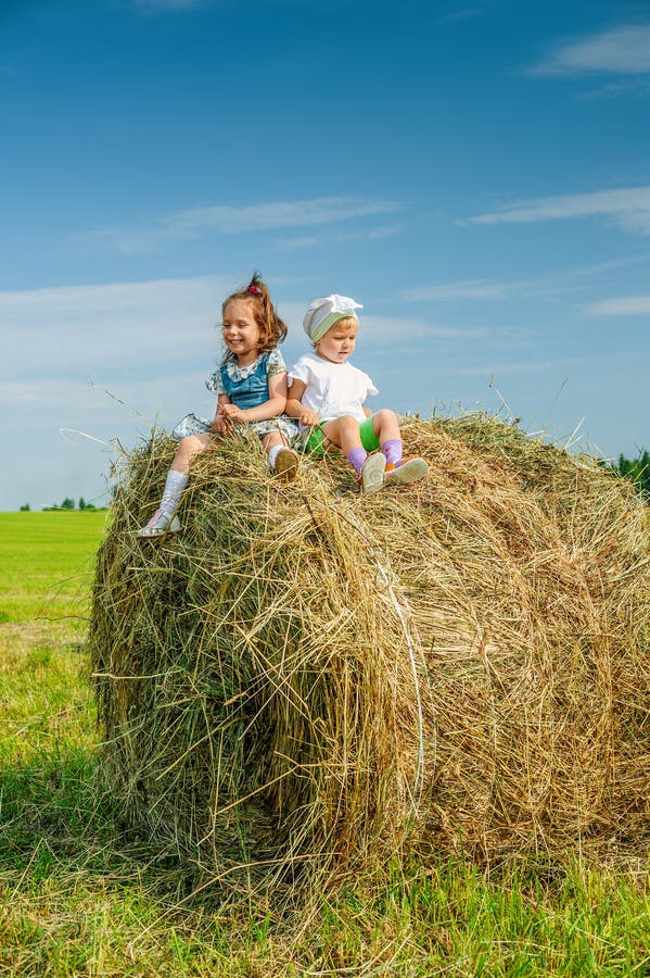 Little girl on haystack. stock photo. Image of child - 67169084