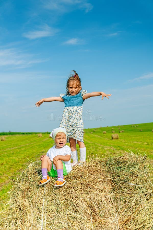Little girl on haystack. stock photo. Image of natural - 67169166
