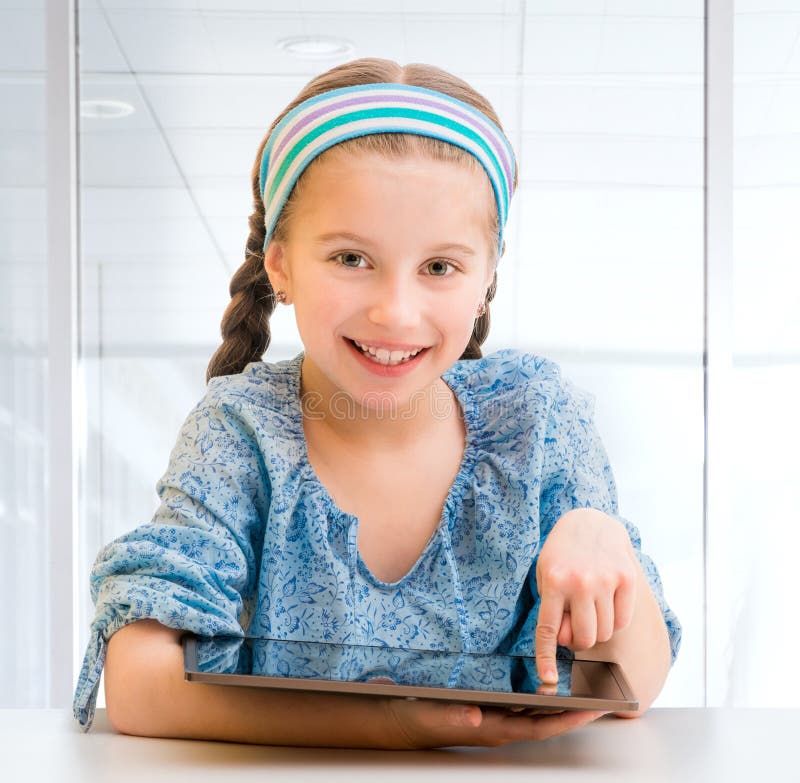 Little girl and her tablet stock image. Image of child - 53671841
