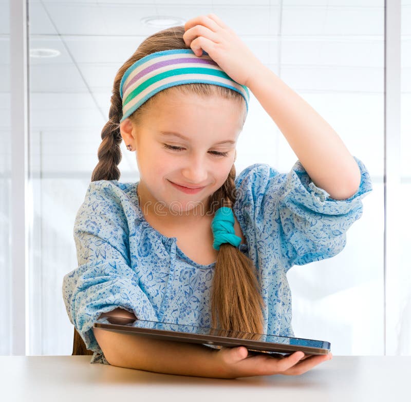Little girl and her tablet stock photo. Image of laptop - 53671842