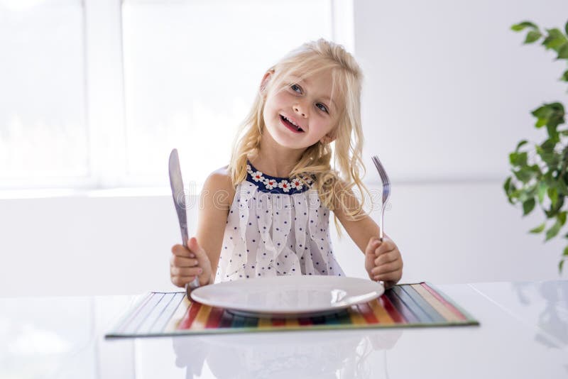 Little Girl Holding Fork Empty Plate Ready for Food. Stock Photo ...