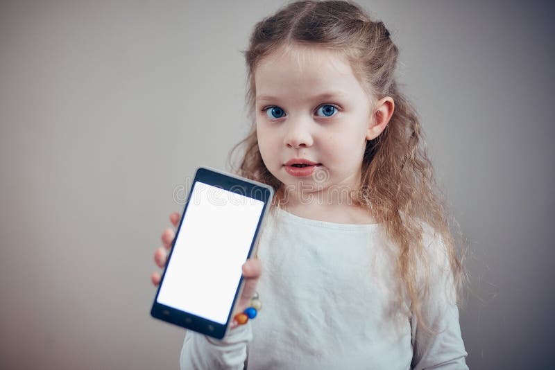 Little Girl Holding a Smartphone with a White Screen Stock Photo ...