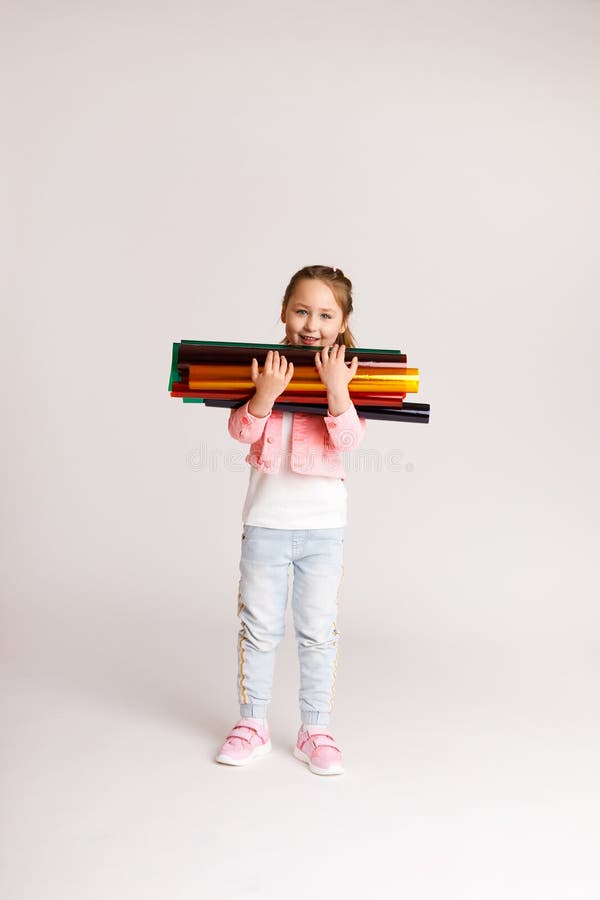 Little Girl Holding a Stack of Colored Foil Tubes and Learning Colors ...