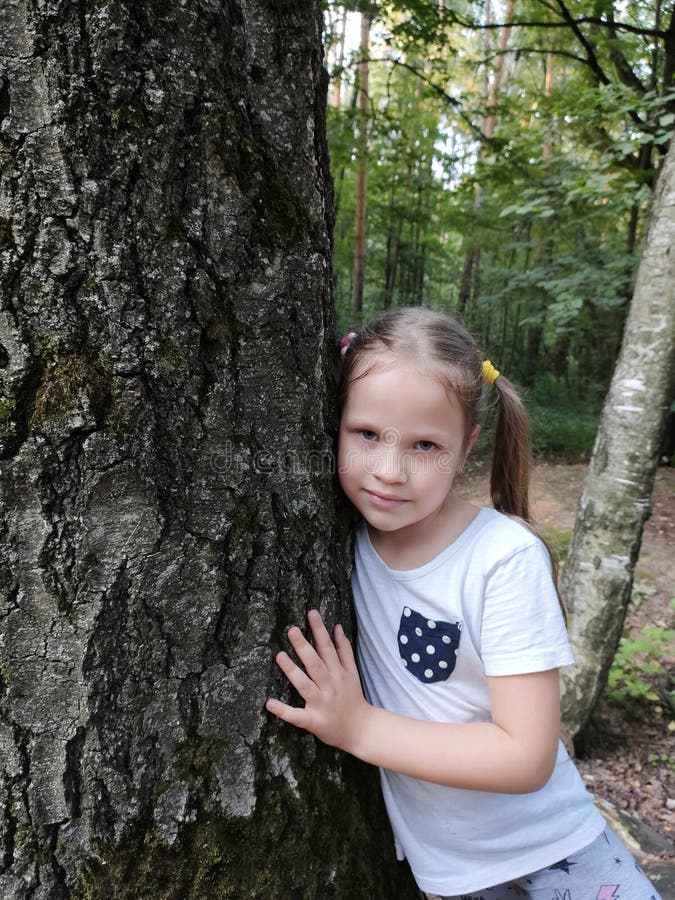 Little Girl Hugging a Tree in the Forest Stock Image - Image of girl ...