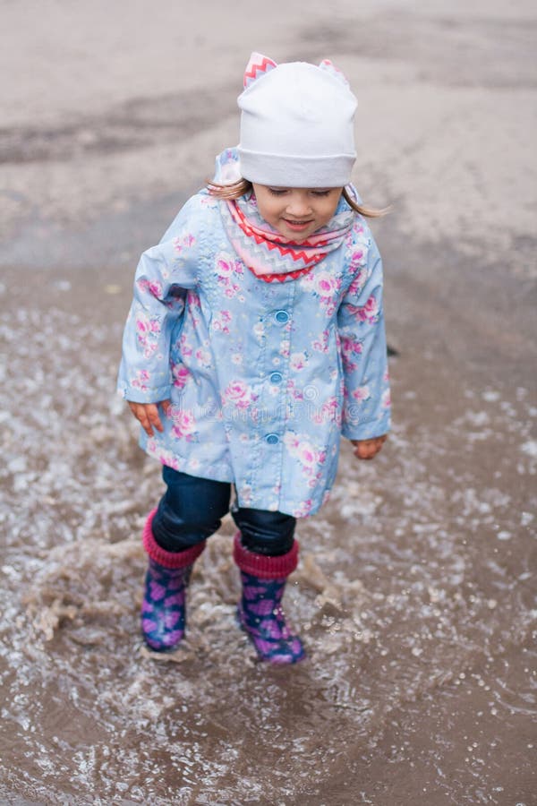 Little Girl Jumping in the Puddle Stock Image - Image of beautiful ...