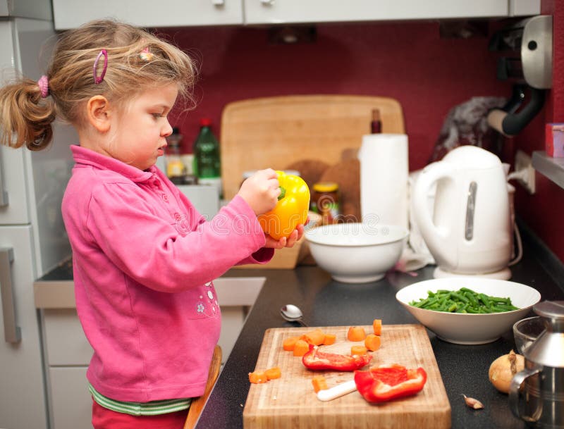 Little girl in the kitchen stock photo. Image of green - 35784222