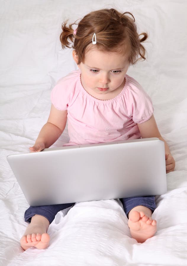 A Little Girl with Computer Stock Image - Image of floor, caucasian ...