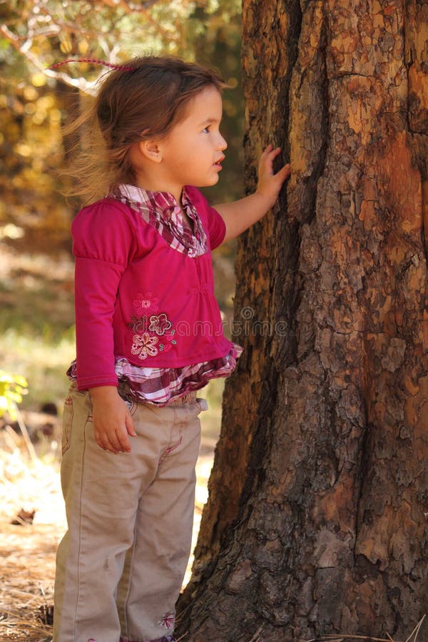 Little Girl Leaning Against Tree Stock Image - Image of stand, camp ...