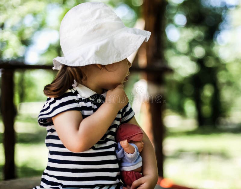 Little girl holding a doll stock photo. Image of nature - 10030982 Little girl holding a doll stock photo. Image of nature - 10030982