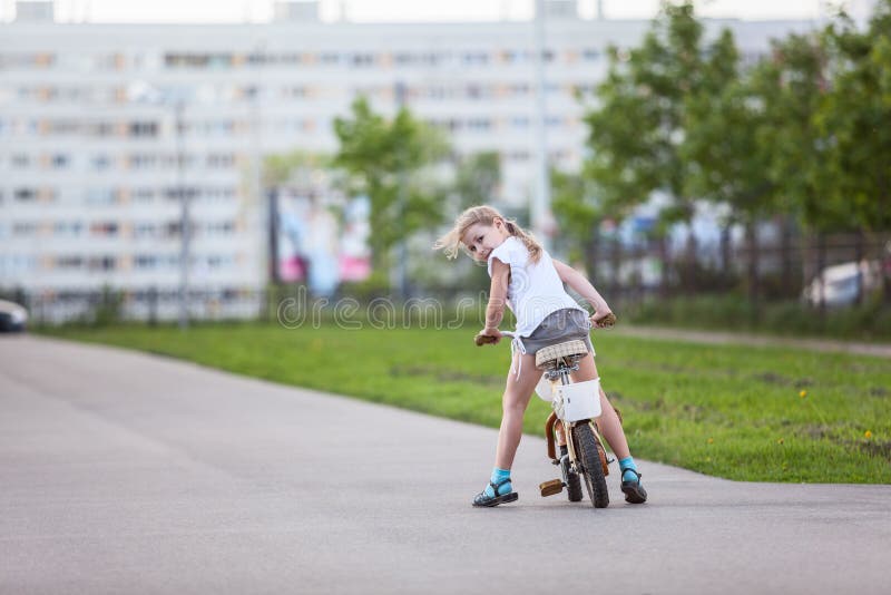 Little Girl Looking Back when Sitting Bicycle Stock Photo - Image of ...