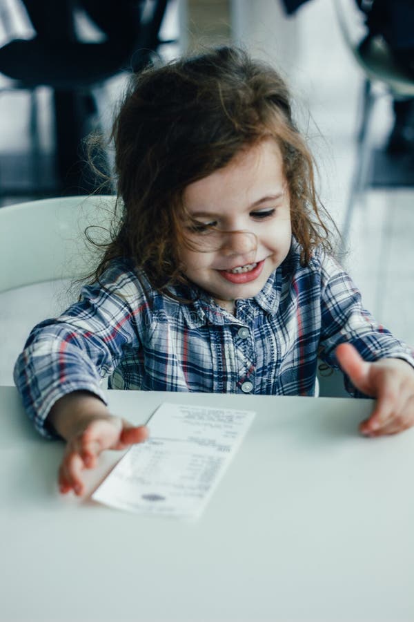 Little Girl Looking on Check in Restaurant. Stock Photo - Image of ...