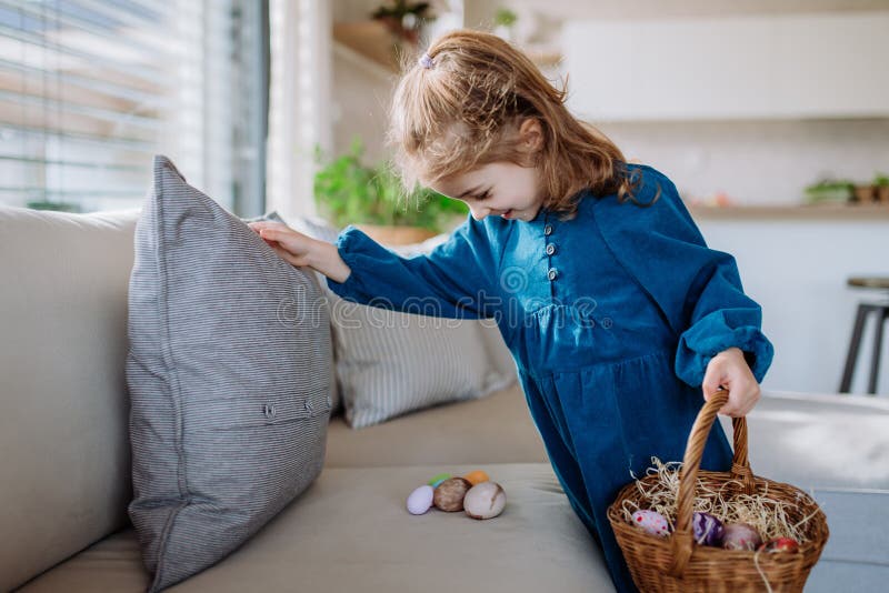 Little Girl Looking for Easter Eggs in Their Home. Stock Image - Image ...