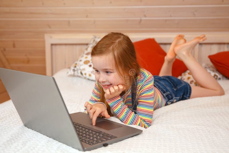 A Little Girl Looks at the Computer with Different Emotions Stock Photo ...