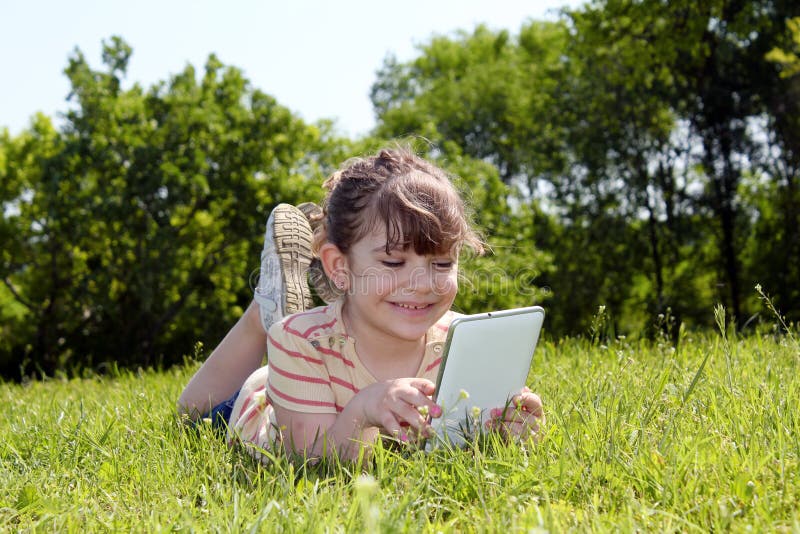 Little Girl Lying and Play with Tablet Pc Stock Image - Image of ...
